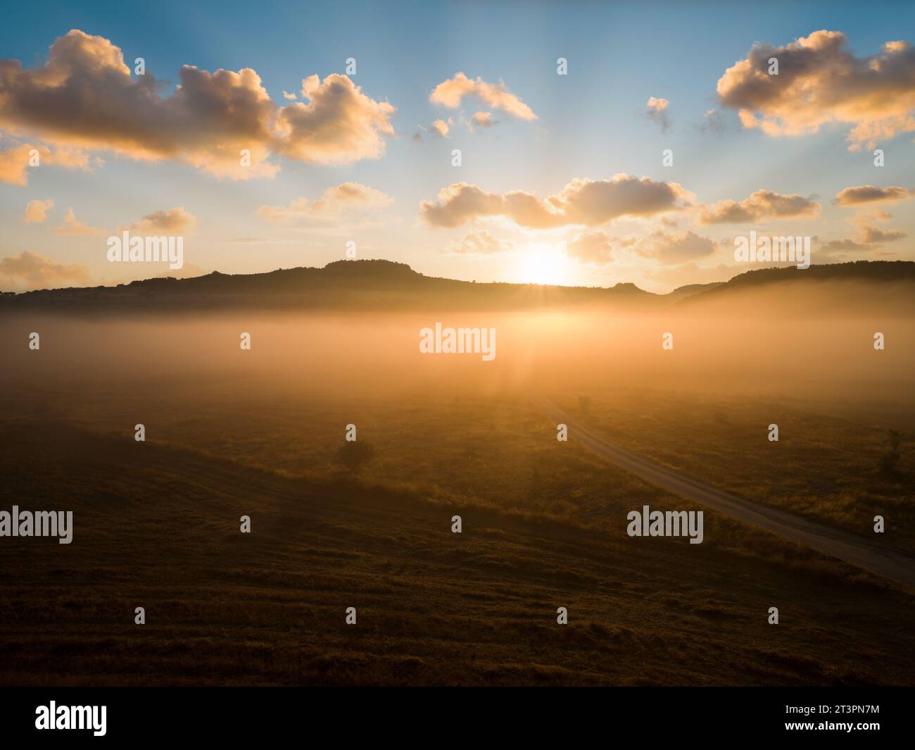 Dry fields at sunrise. Dramatic sunrise in foggy fields Stock Photo - Alamy
