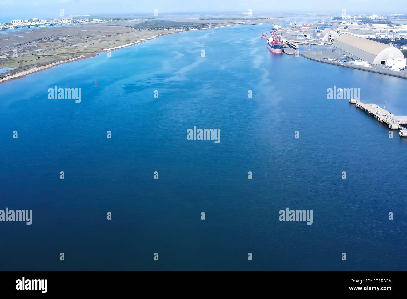 Flying over the Odiel river through the outer port of Huelva industrial ...