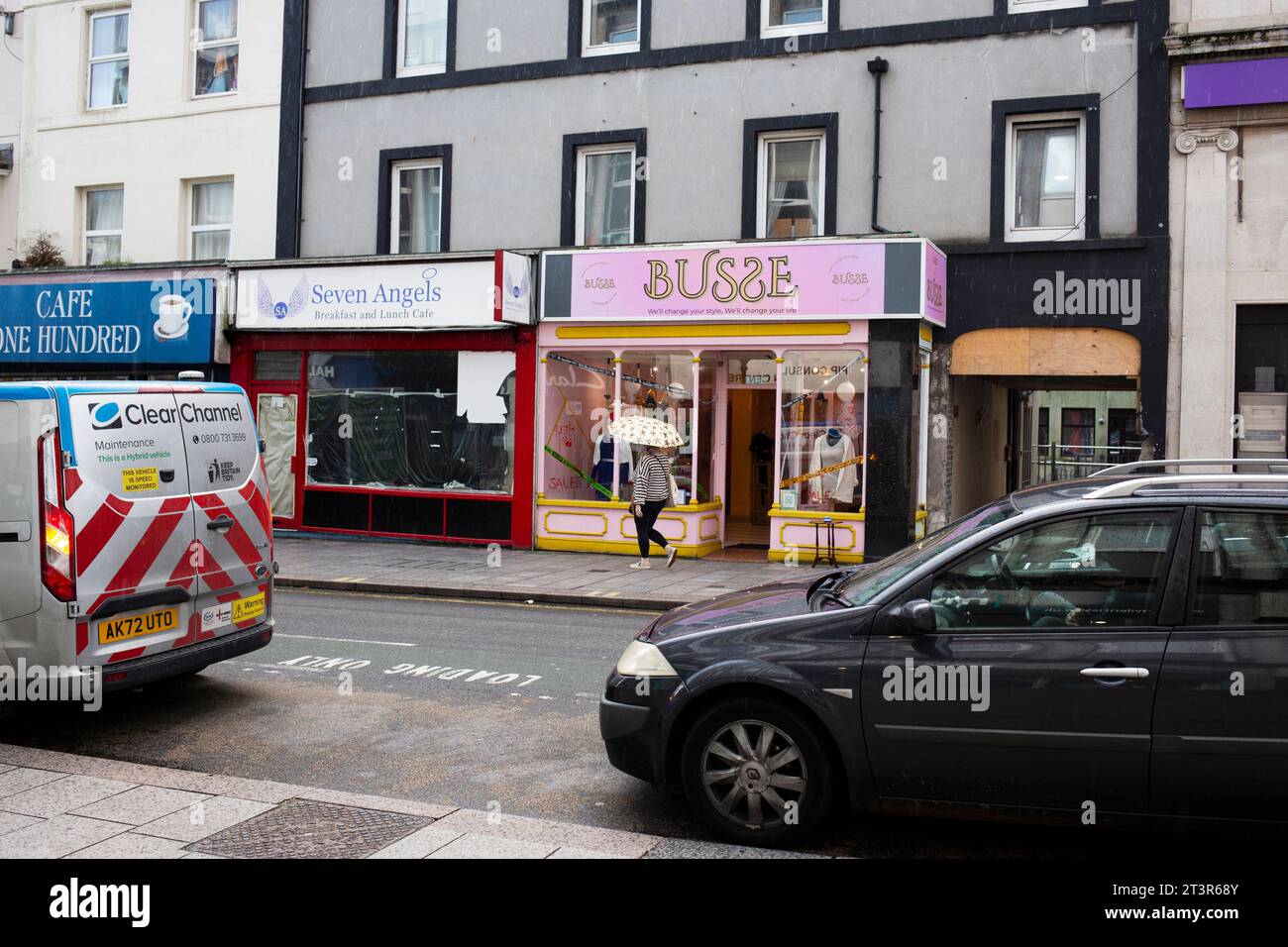 Union Street Torquay during light rain and with lady holding umbrella ...
