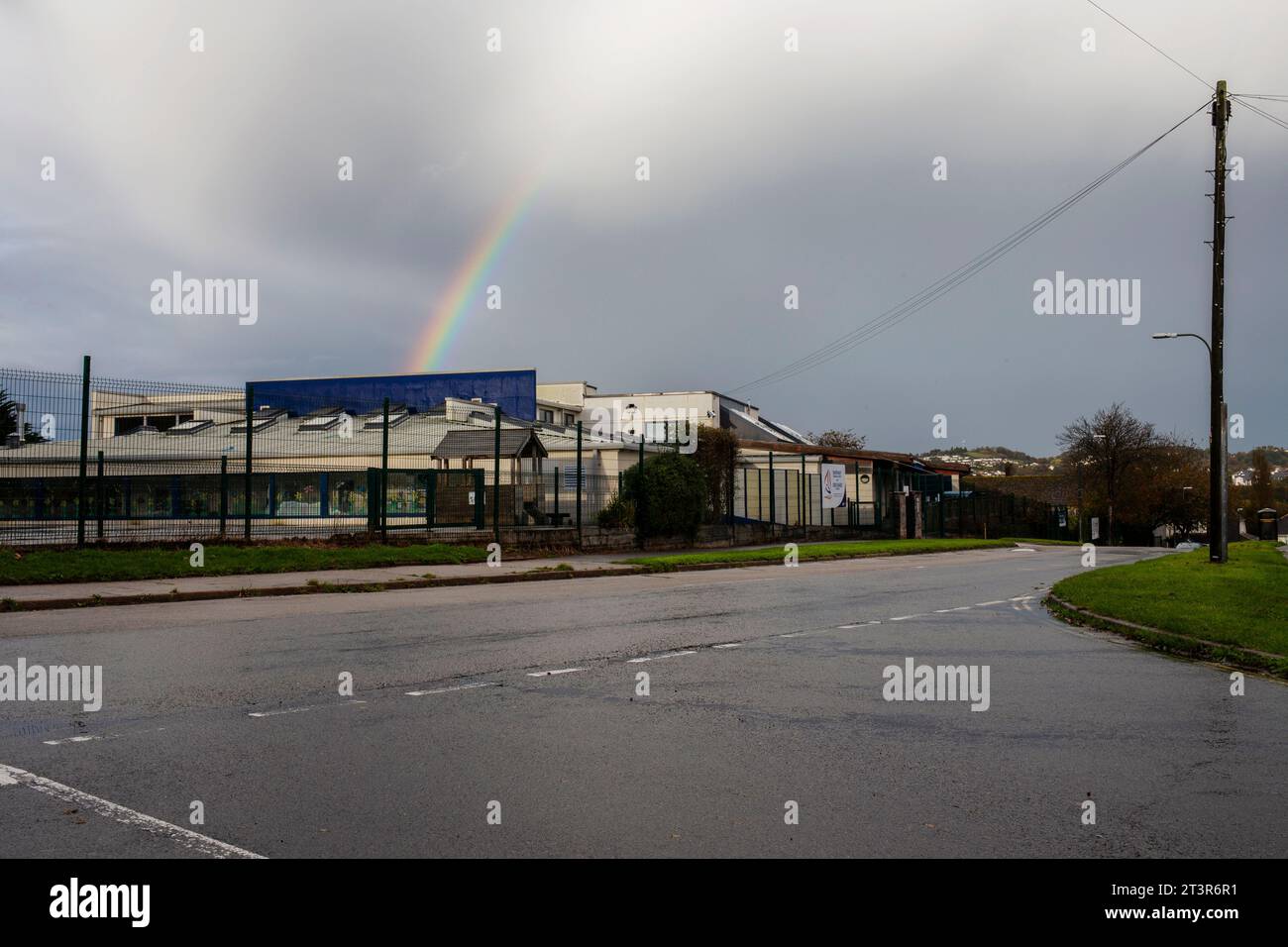 Shiphay school in Torquay from a distance with a rainbow going into a ...