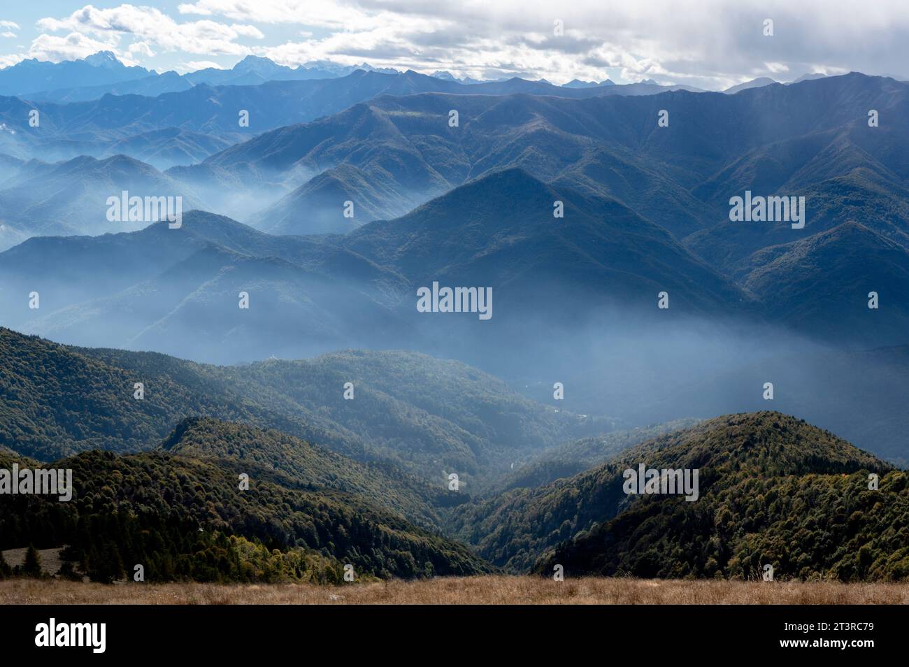 Upper Maira valley. Autumn panorama, with sun and fog, on the peaks of ...