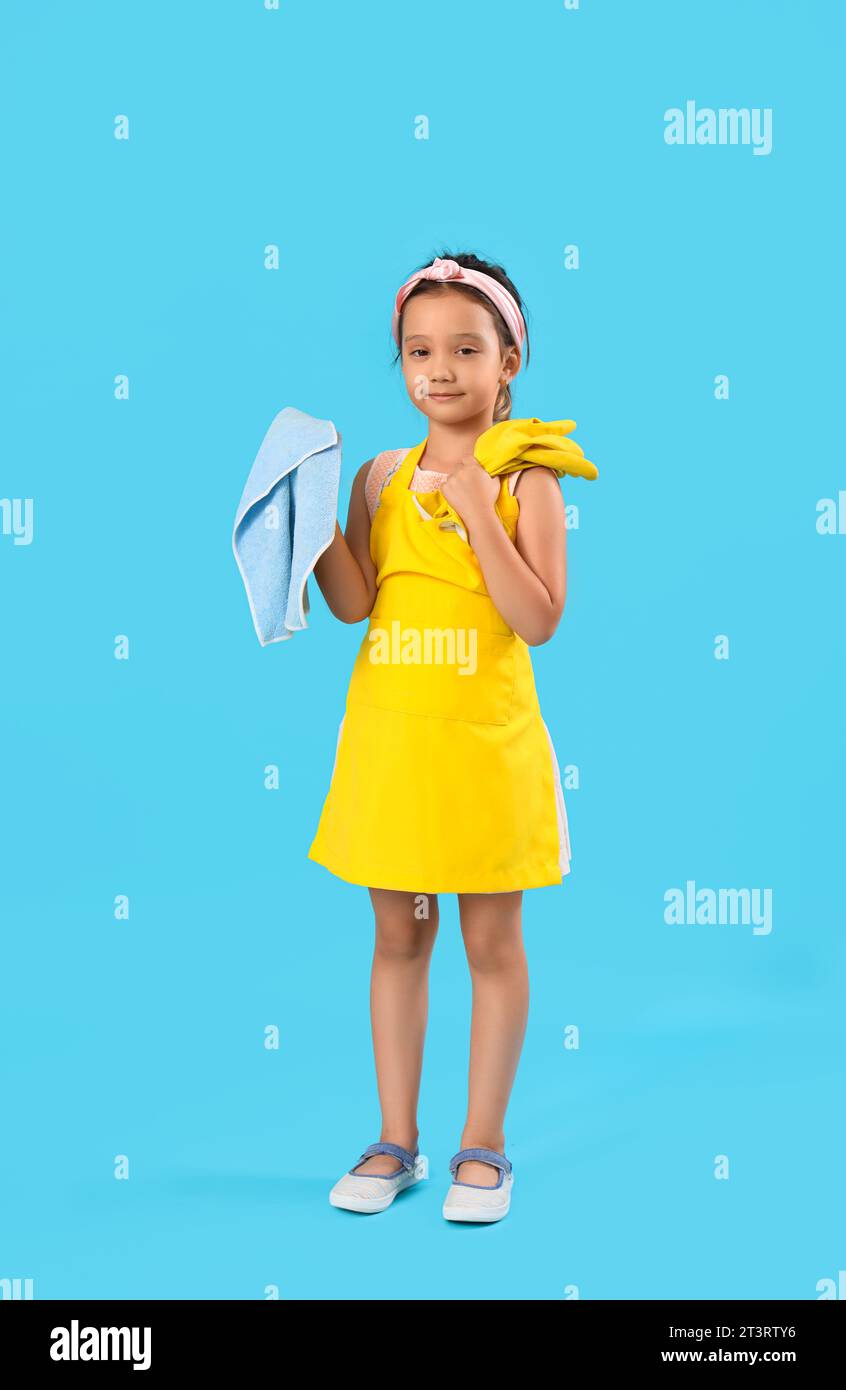 Cute little janitor with rag and rubber gloves on blue background Stock ...