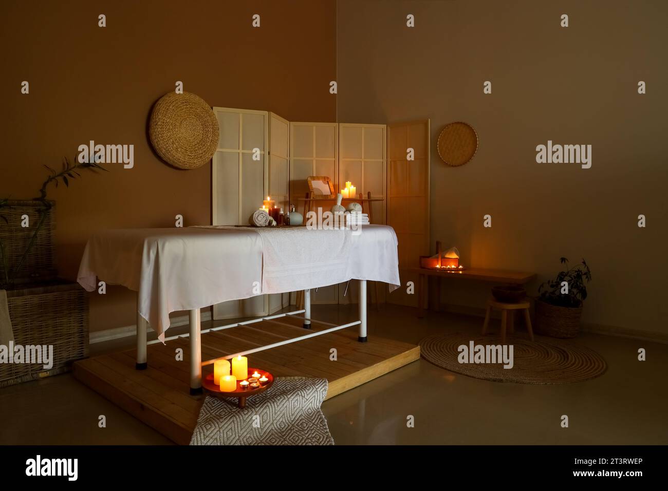 Interior of dark spa salon with couch and burning candles Stock Photo ...