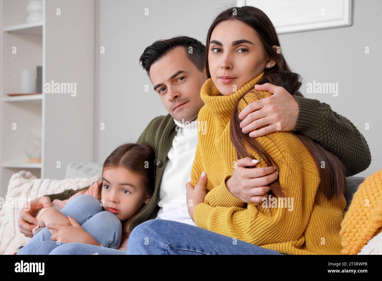 Frozen family at home with lack of heating Stock Photo - Alamy
