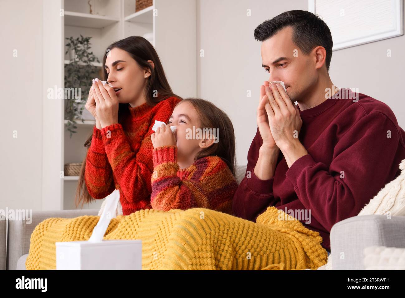 Frozen family at home with lack of heating Stock Photo - Alamy