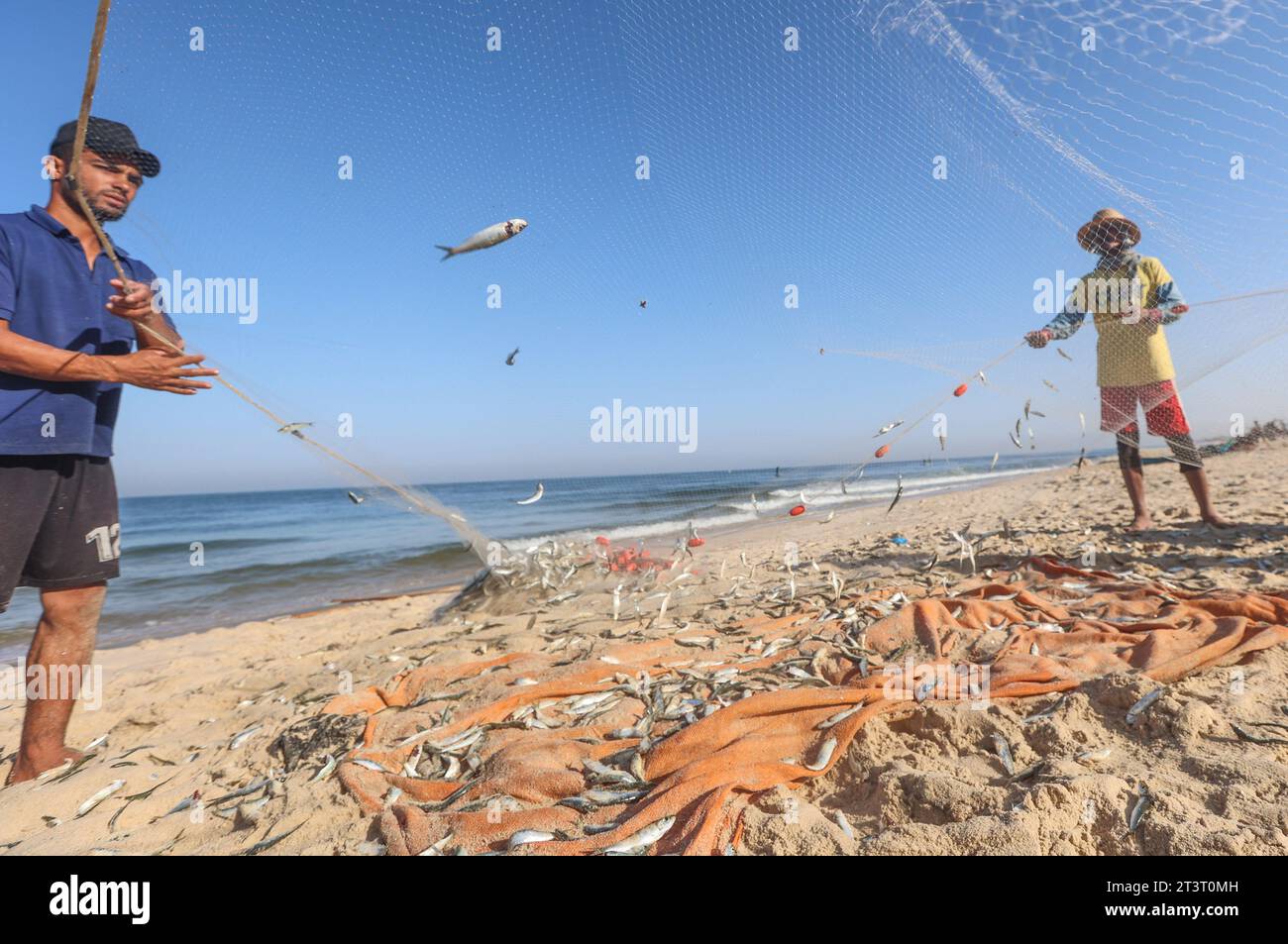 Palestinian fishermen fishing on the beach of Al-Nusirat central Gaza ...