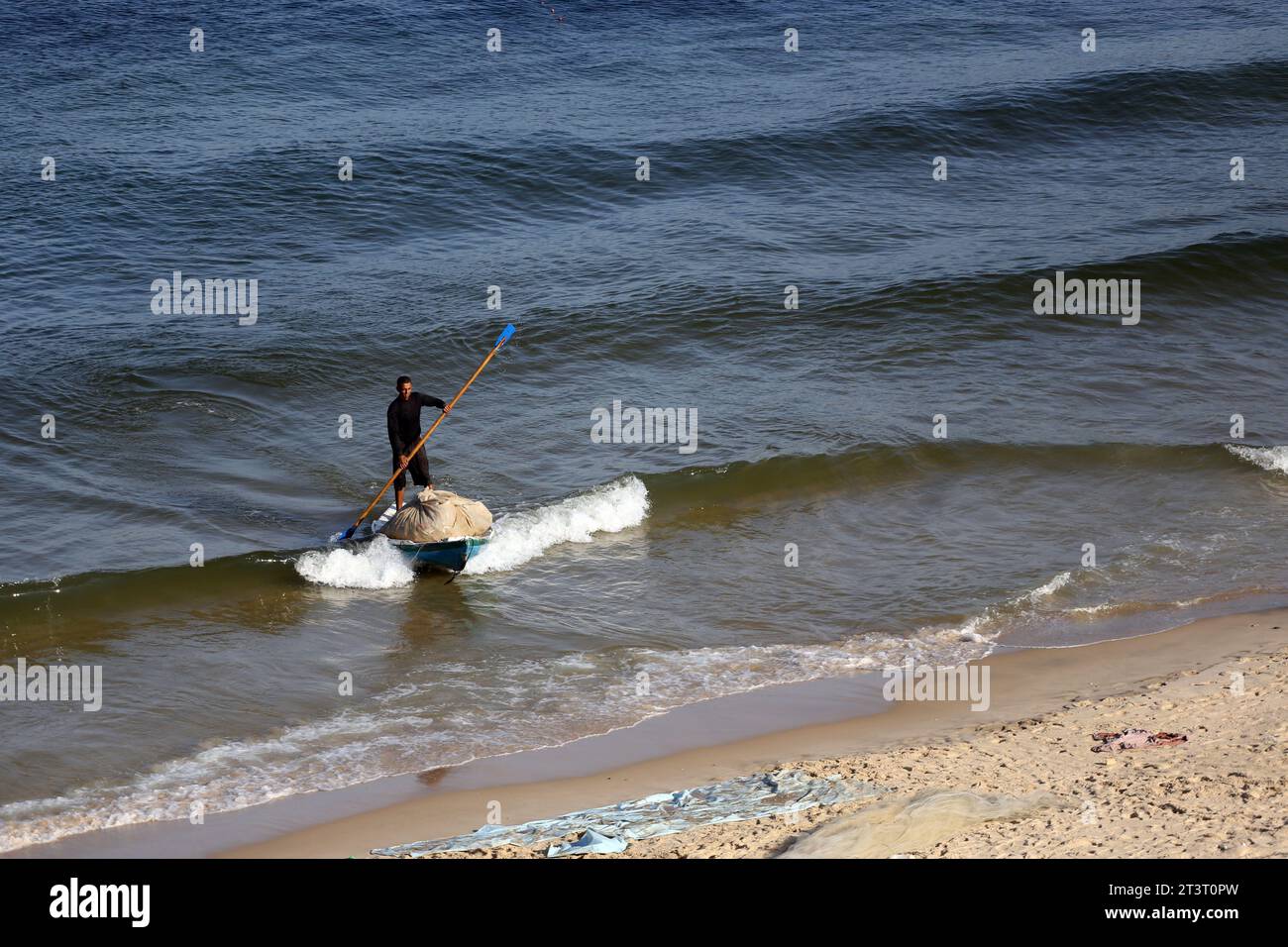 A Palestinian fisherman fishing on the beach of Al-Nusirat central Gaza ...