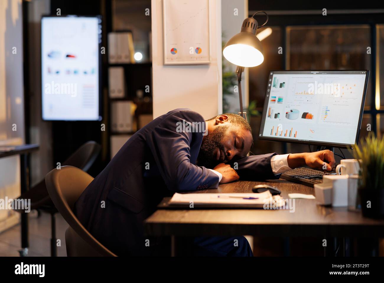 Tired executive worker sleeping on desk in startup office, workaholic ...