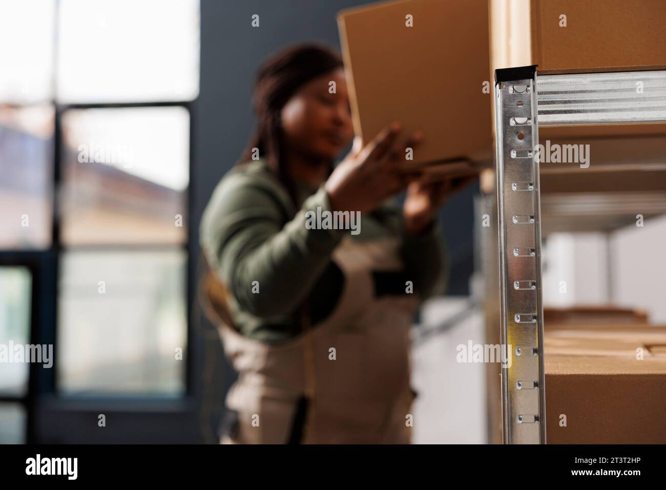 Selective focus of metallic shelves full with carton boxes, african ...