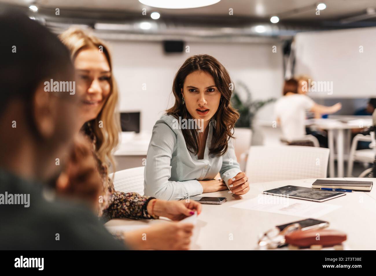 Brunette female having misunderstanding with her black male colleague ...
