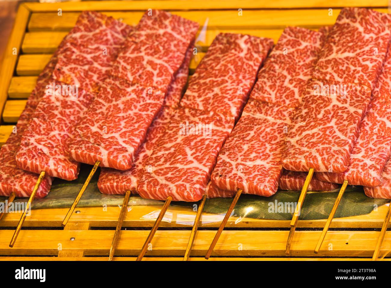 sticks with beautiful Wagyu beef at a Japanese street kitchen, in Tokyo ...