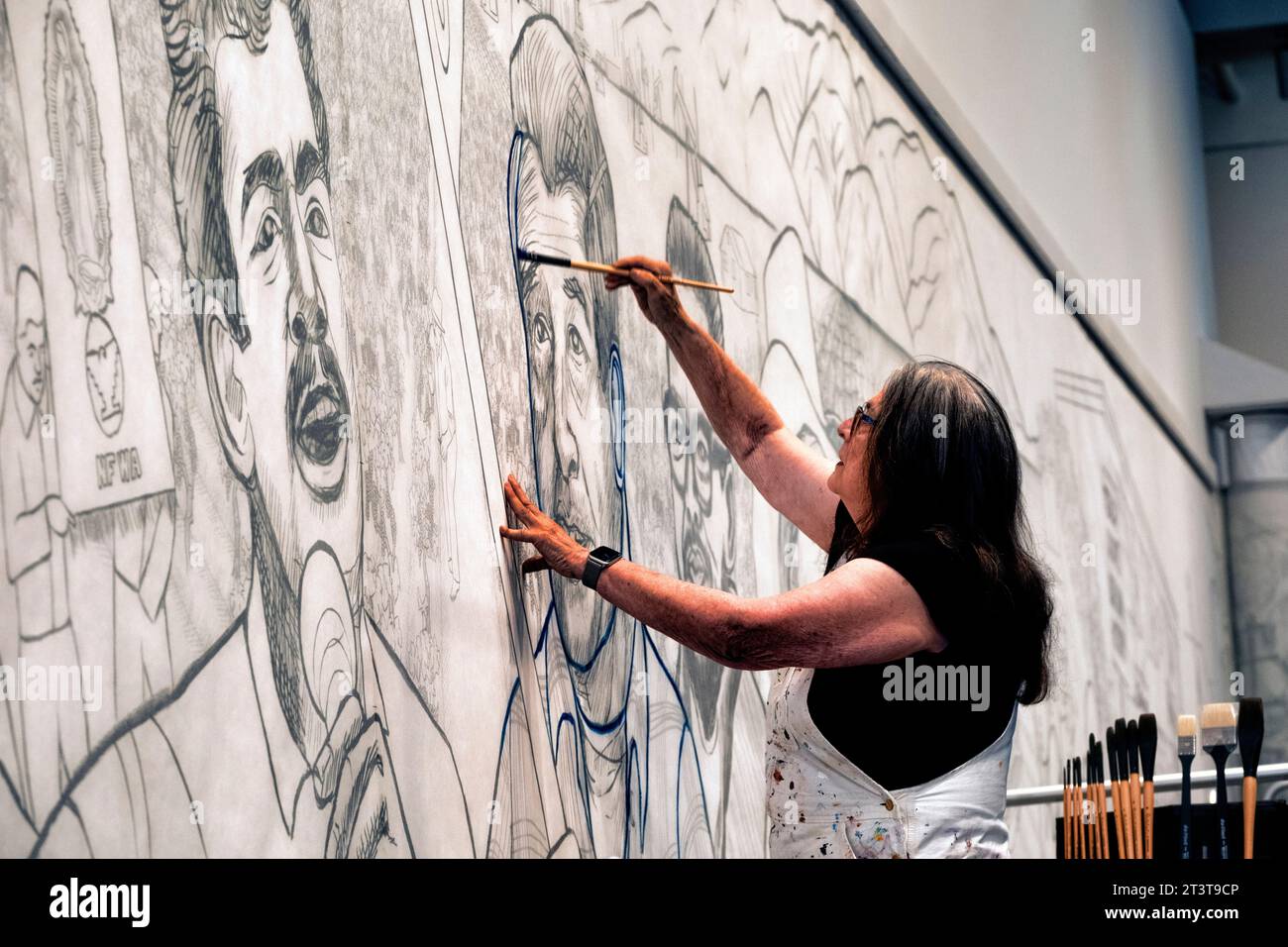 Artist Judy Baca outlines the likeness of American labor leader Cesar ...