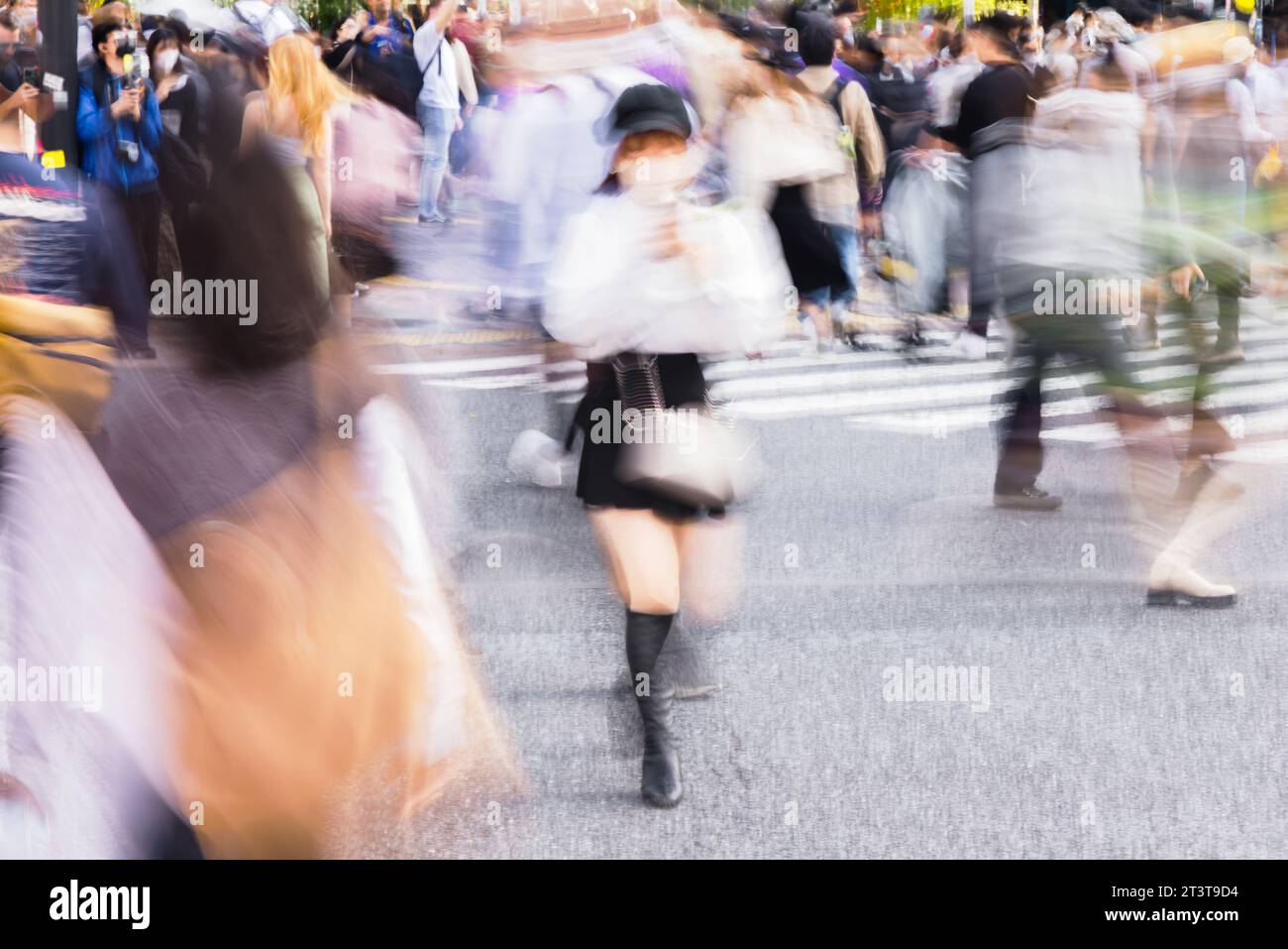 picture with motion blur effect of crowds of people crossing the famous ...