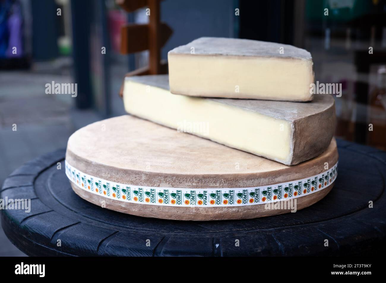 Picture of a wheel of Comte cheese sliced and ready for sale in ...
