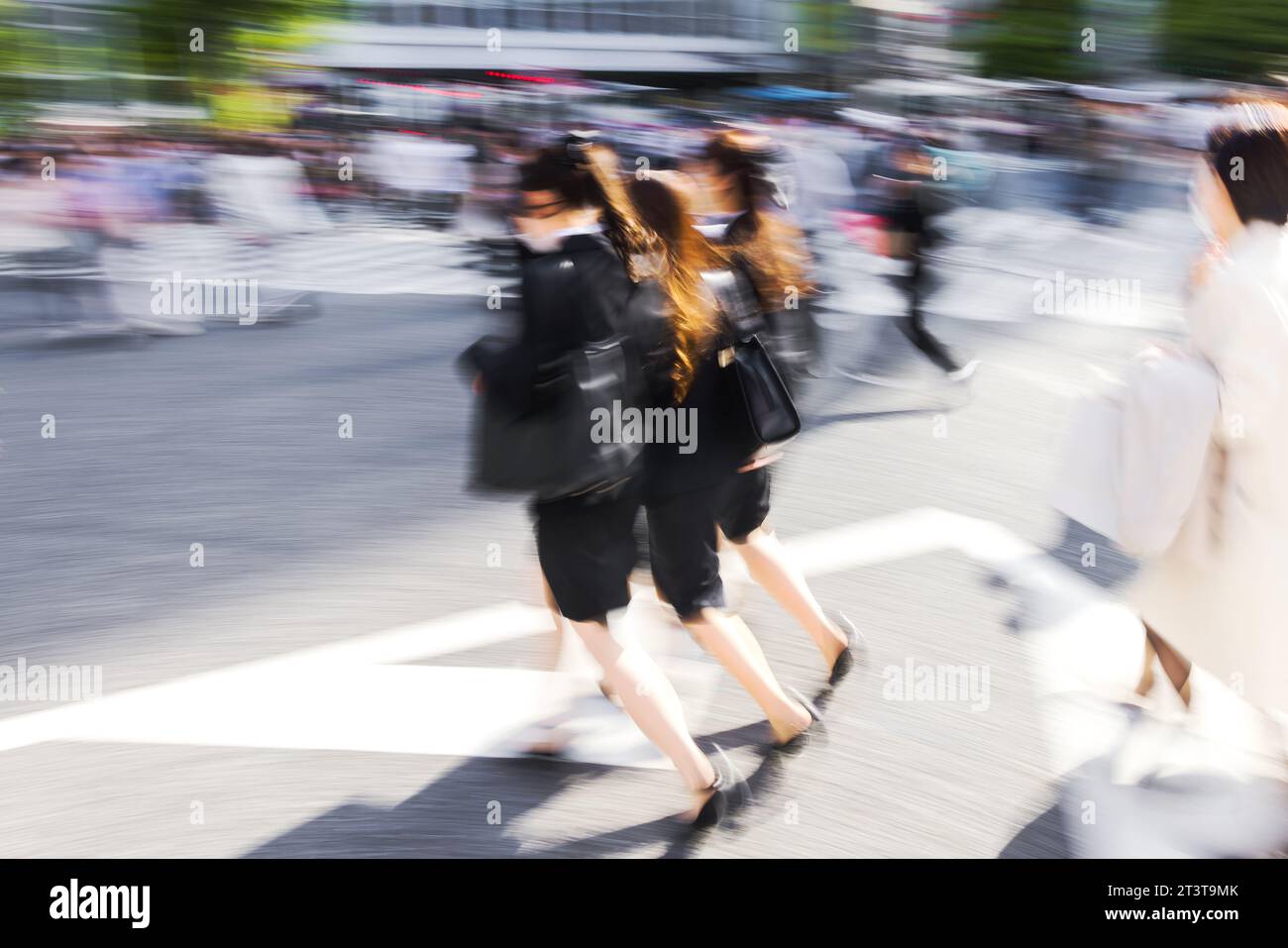 picture with motion blur effect of young Japanese women crossing the ...