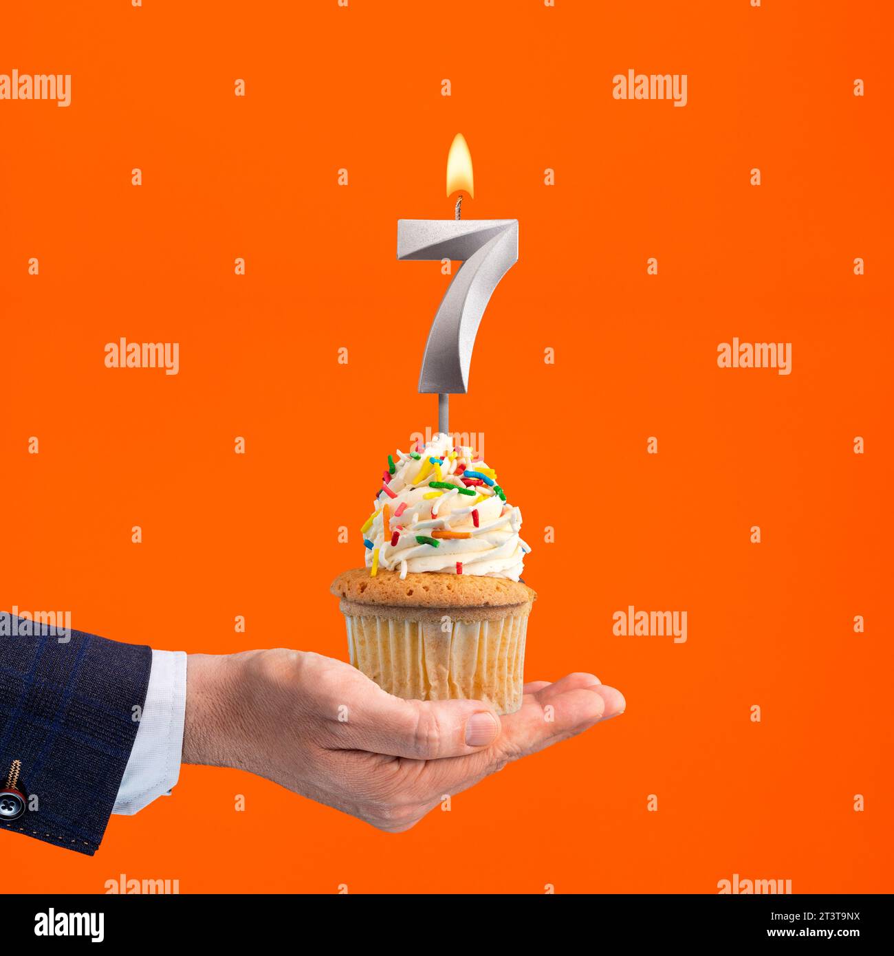 The hand that delivers cupcake with the number 7 candle - Birthday on ...