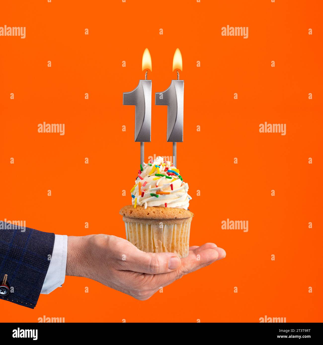 The hand that delivers cupcake with the number 11 candle - Birthday on ...