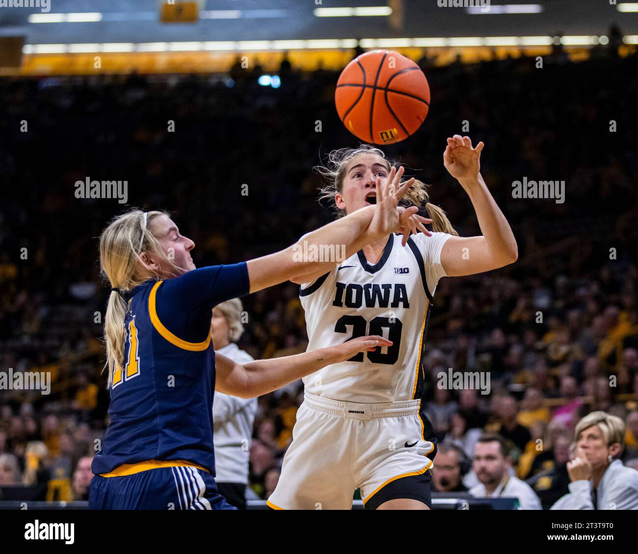 Clarke guard Madison Lindauer (11) fouls Iowa Hawkeyes guard Kate ...