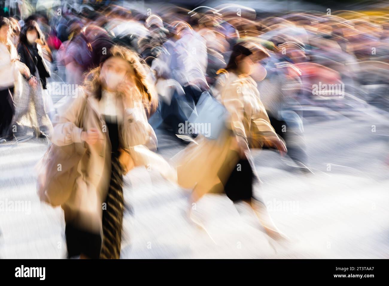 picture with motion blur effect of crowds of people crossing the famous ...