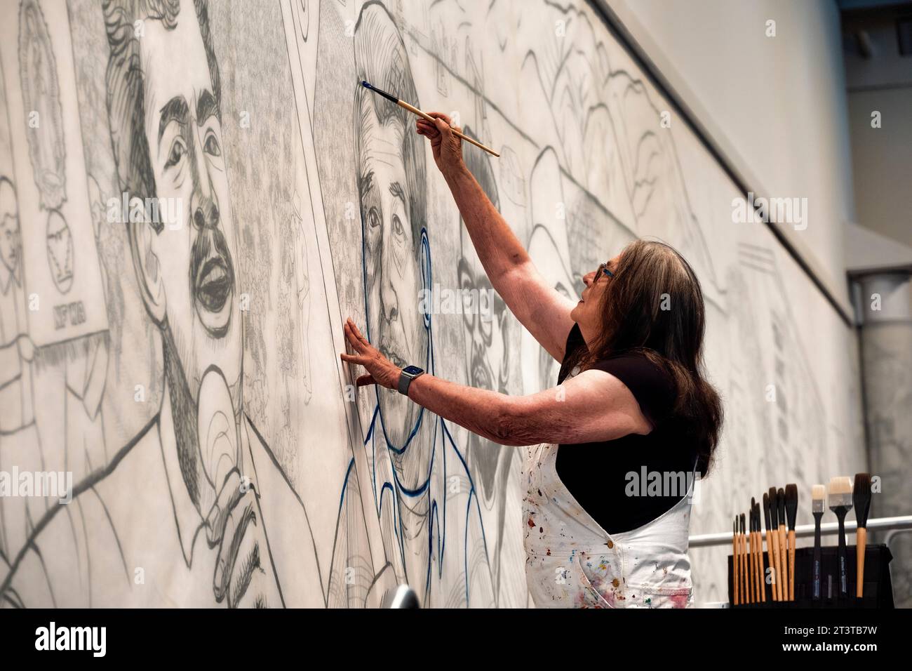 Artist Judy Baca outlines the likeness of American labor leader Cesar ...