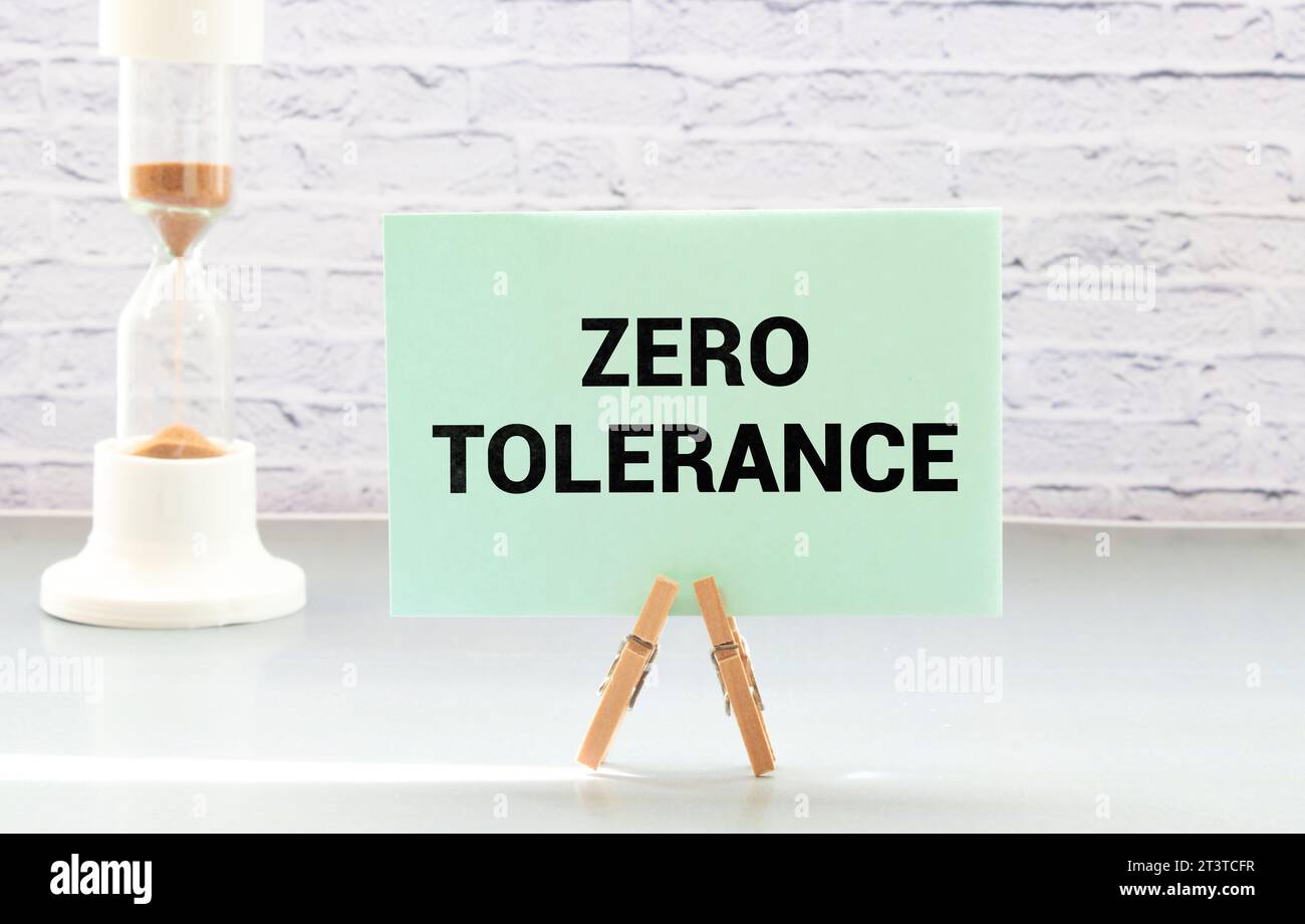 ZERO TOLERANCE text on a paper clipboard with chart and notebook on ...
