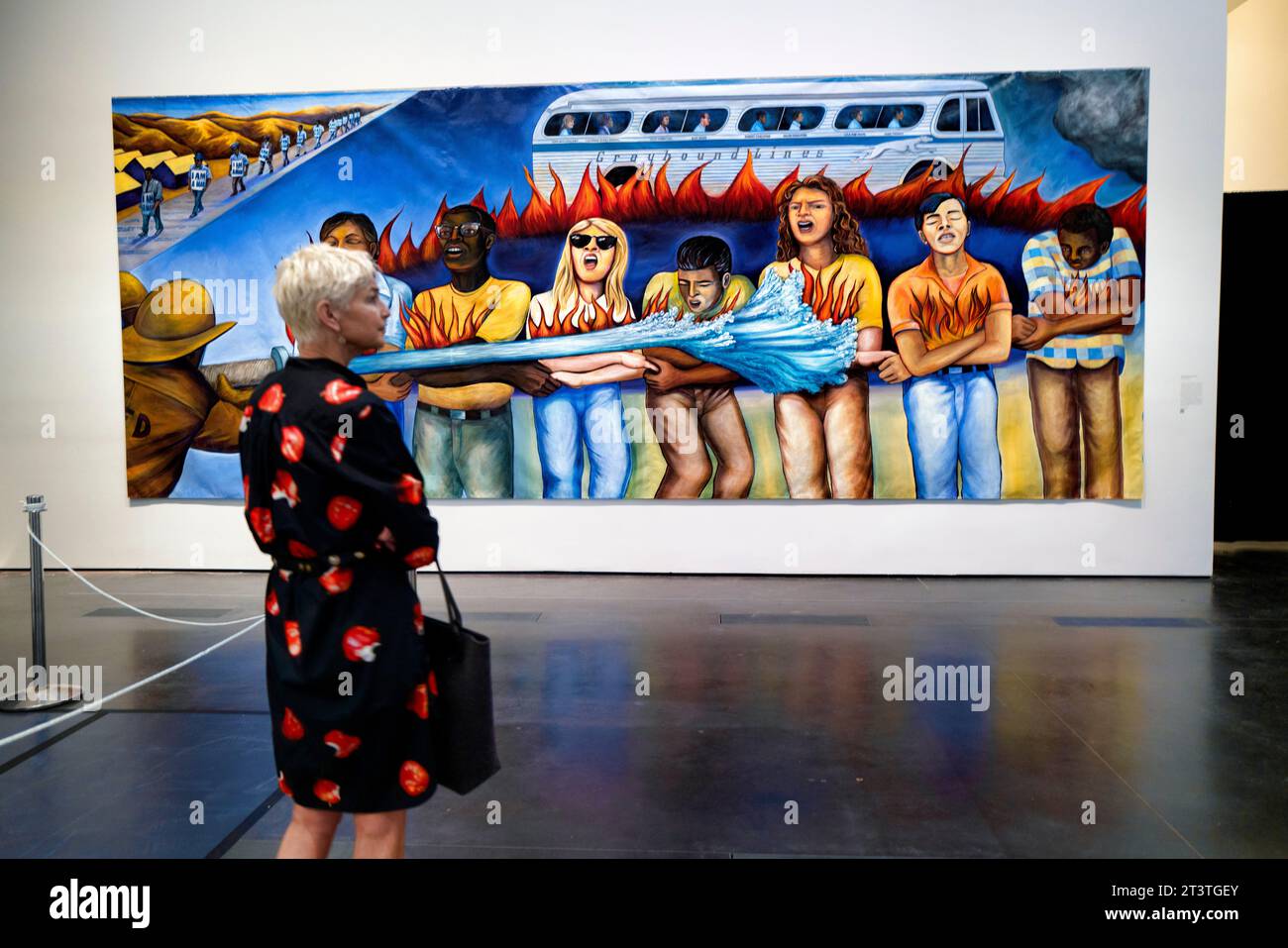 A visitor views artist Judy Baca's mural "Generation on Fire", a newly ...