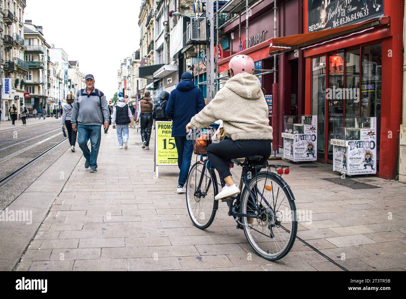Reims, France - October 26, 2023 People rolling with a bicycle in the ...