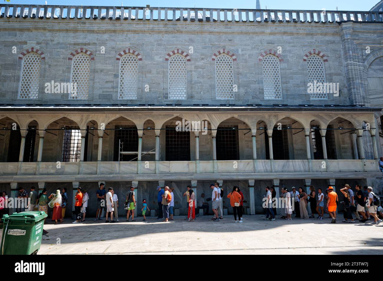 Crowd of tourists patiently wait in line to enter the iconic blue ...