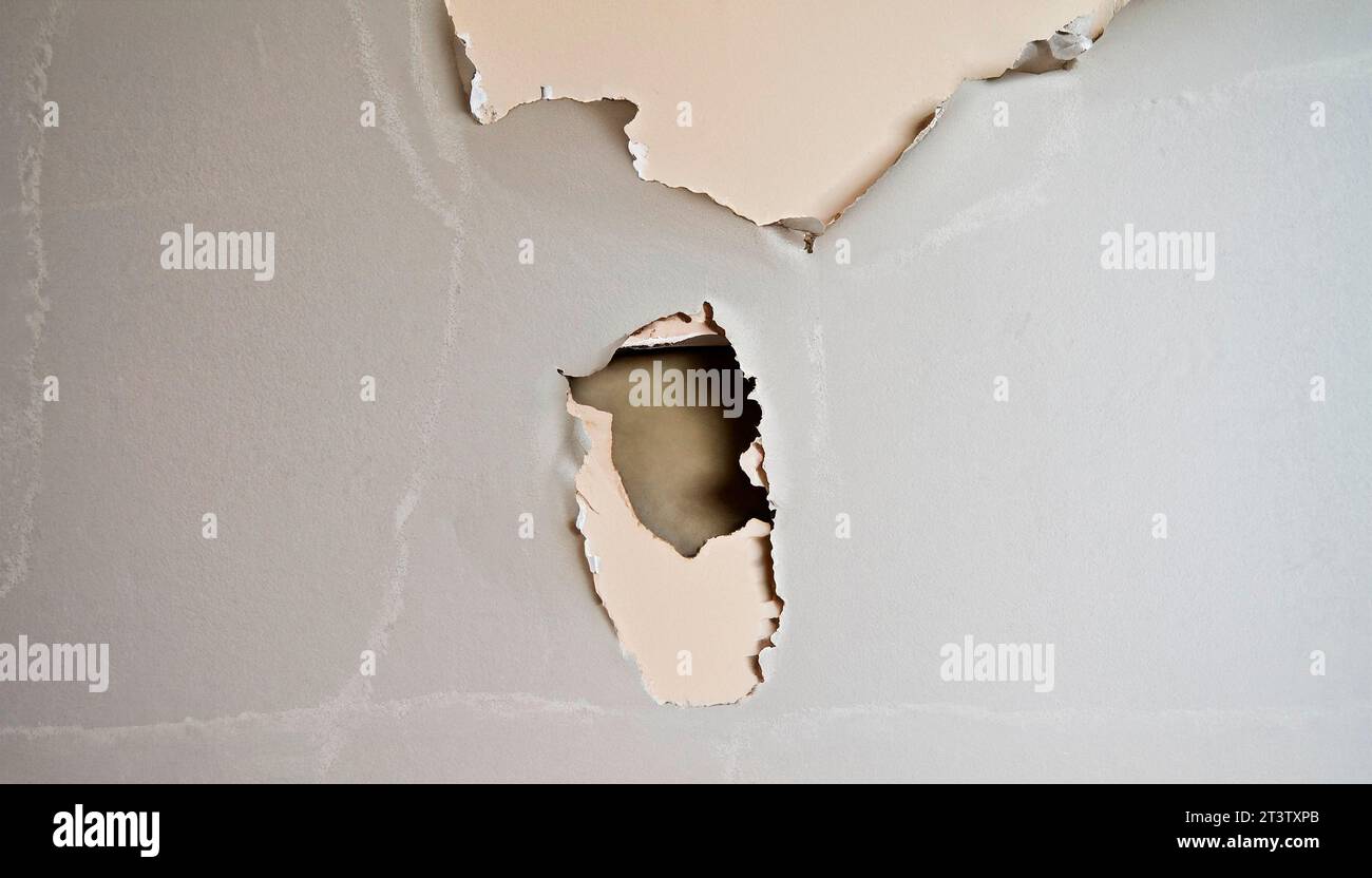 Busted drywall with torn hole Stock Photo - Alamy