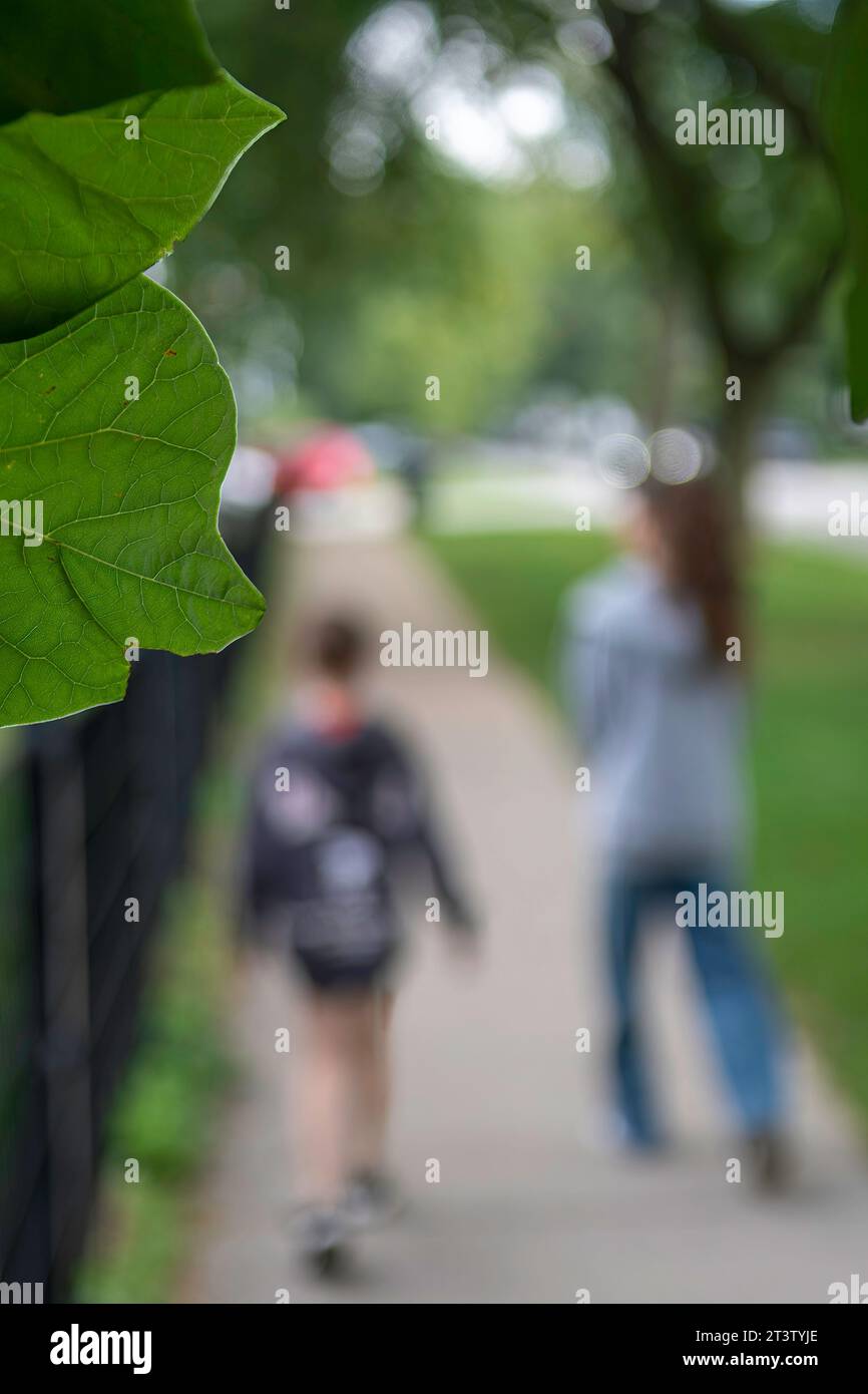 High resolution image of a couple of kids who are out of focus walking ...