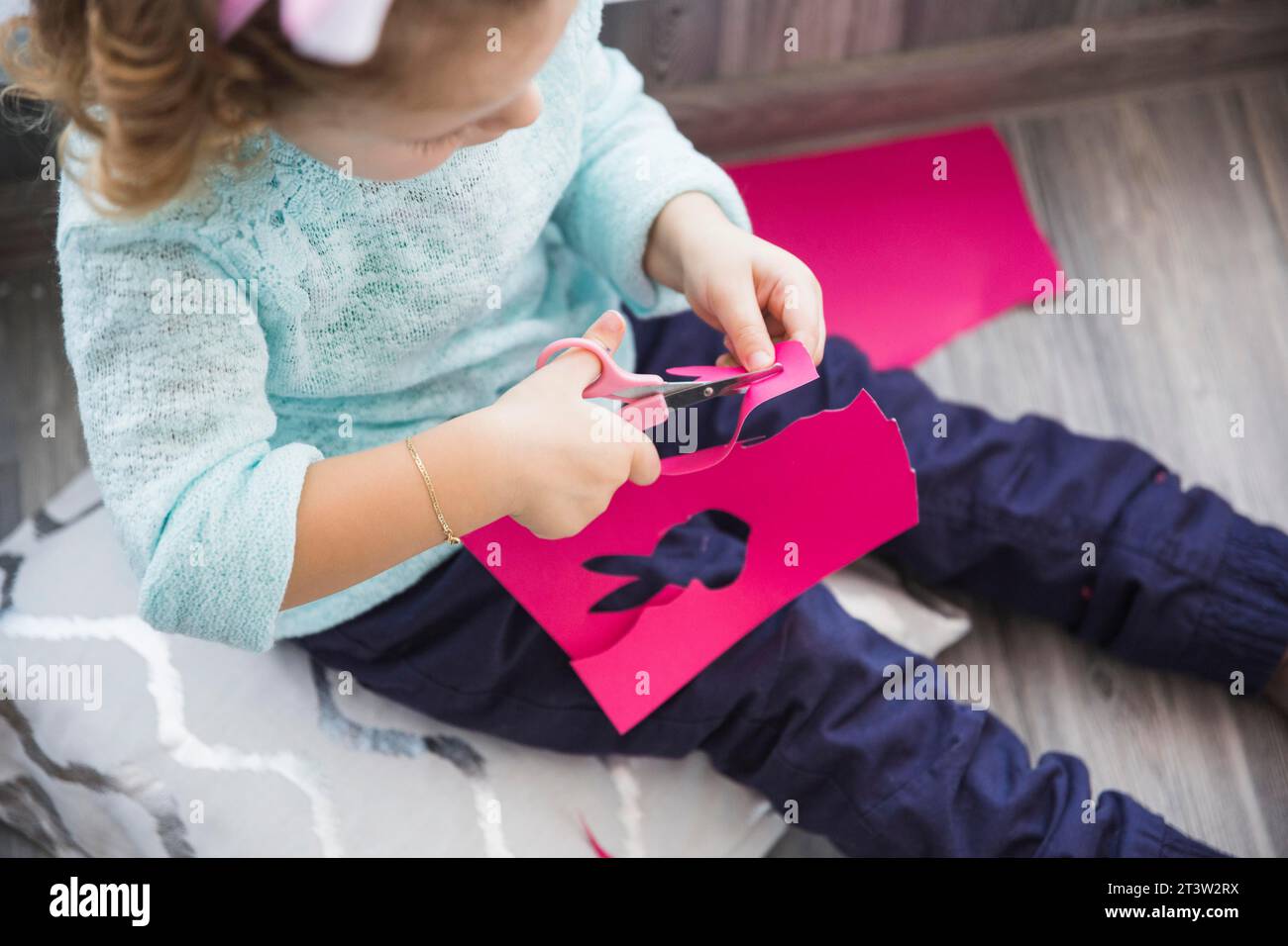 Crop girl cutting rabbits Stock Photo - Alamy