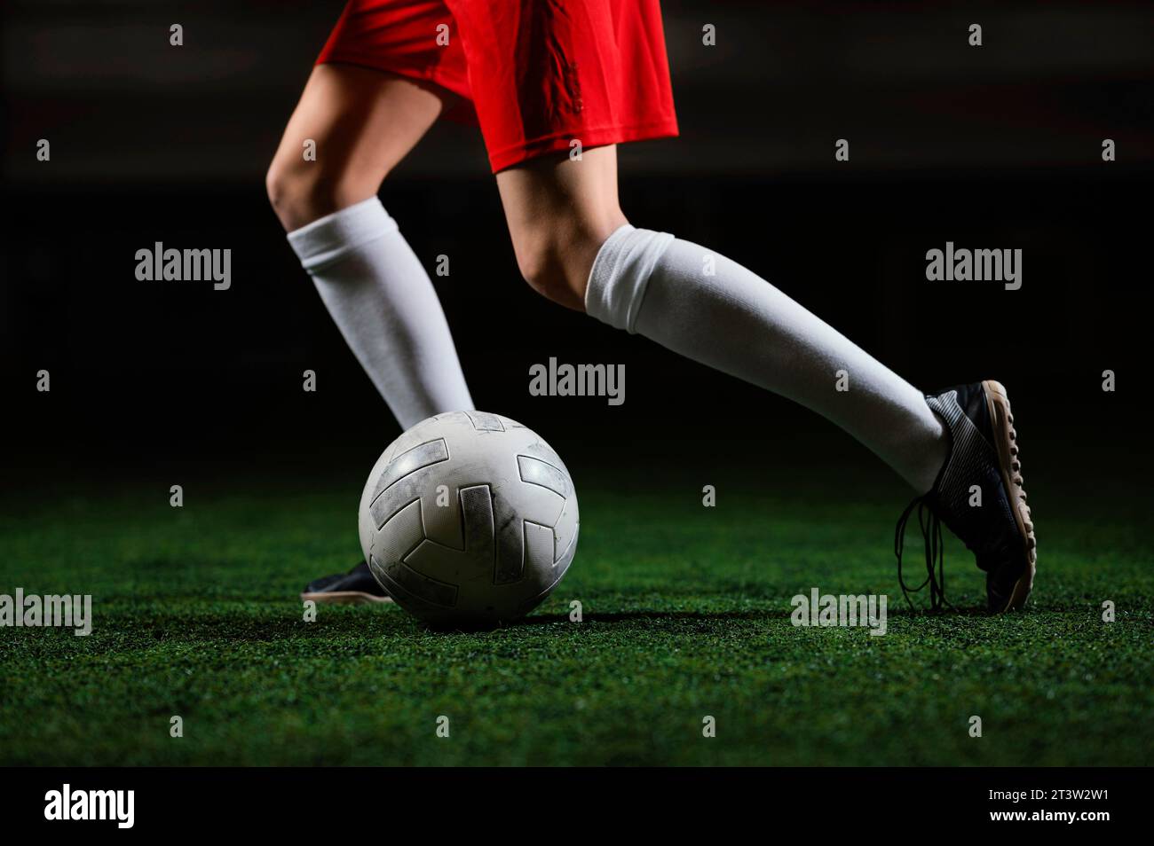 Female football player running ball Stock Photo - Alamy