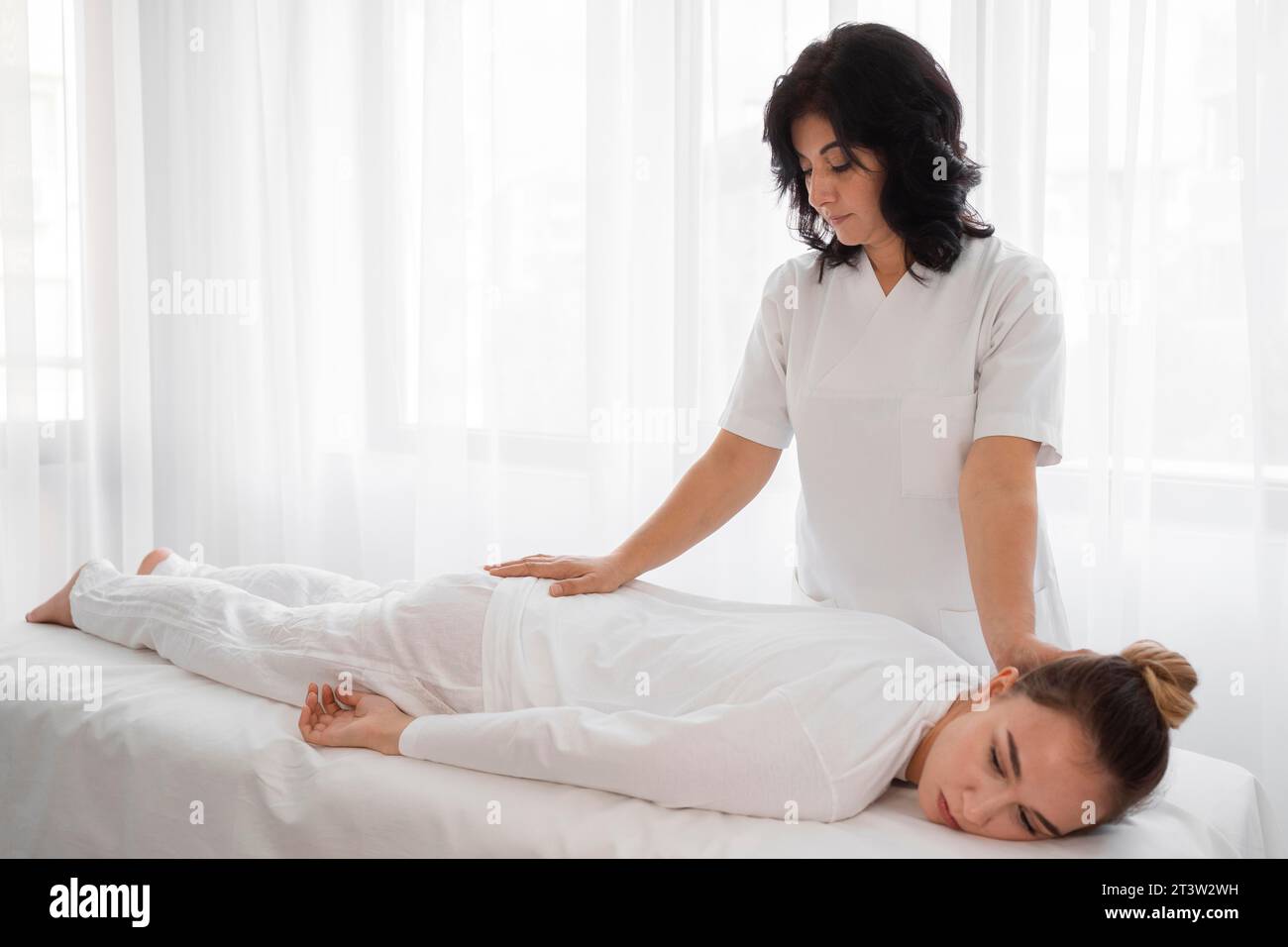 Female osteopathist treating girl hospital Stock Photo - Alamy