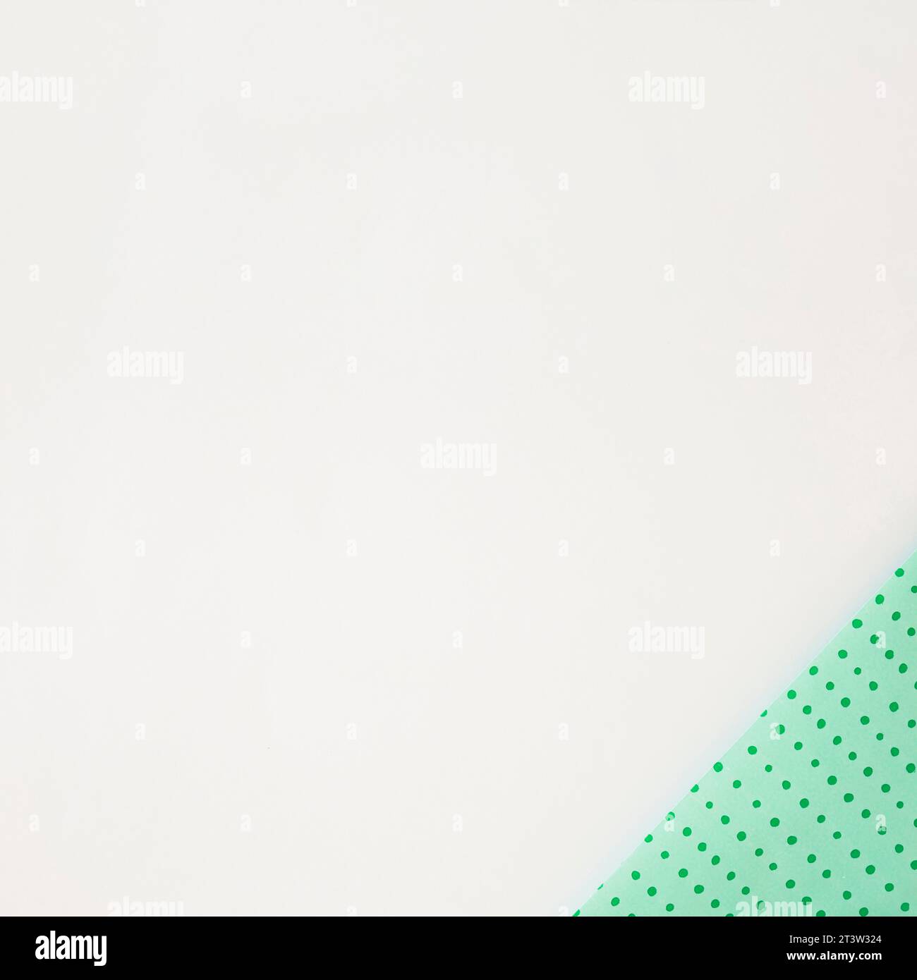 Polka dot green wrapped paper corner white background Stock Photo - Alamy