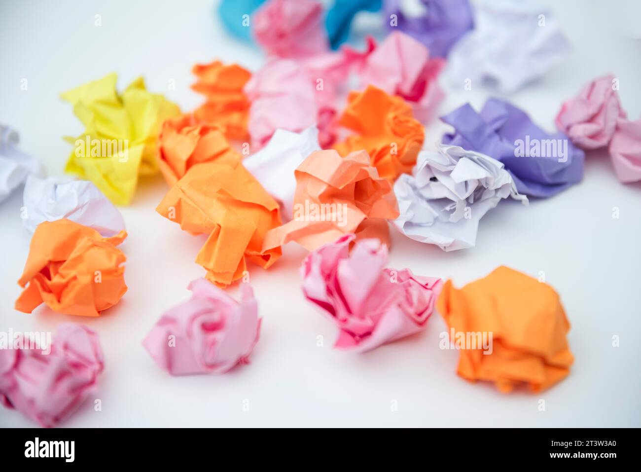 Scattered crumple paper white background Stock Photo - Alamy