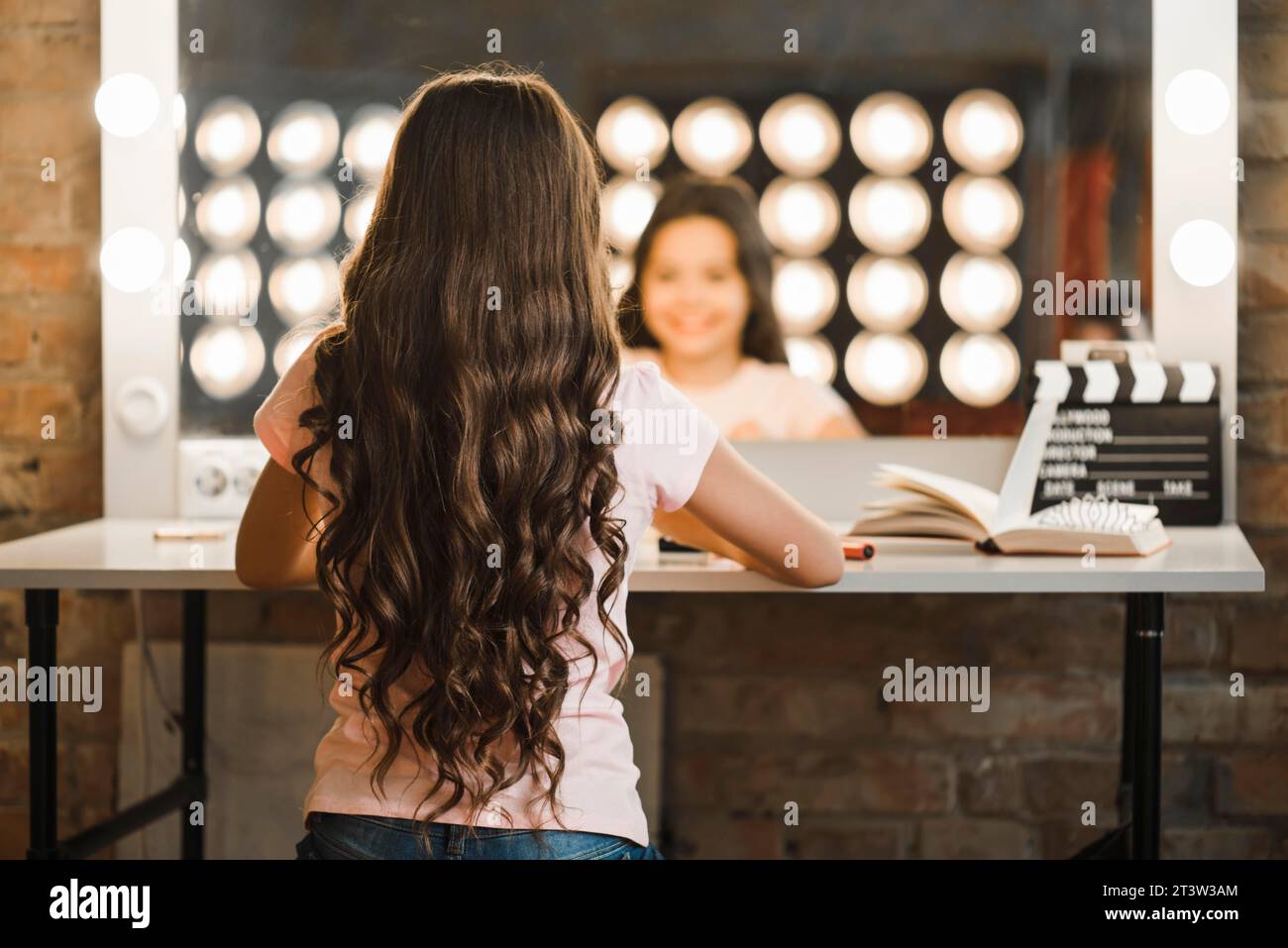 Rear view girl with long brunette wavy hair sitting makeup room Stock ...