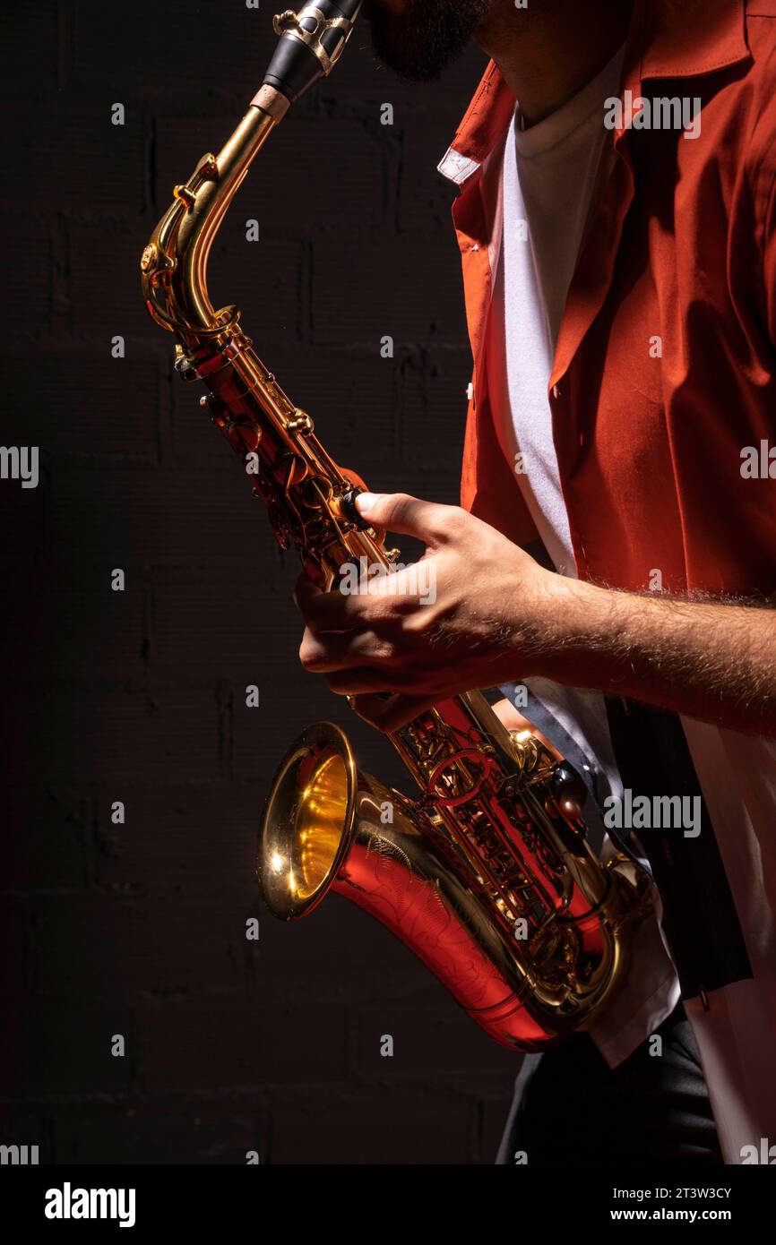 Side view male musician playing saxophone Stock Photo - Alamy