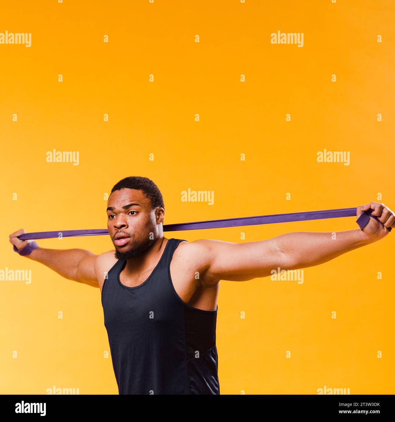 Side view athletic man pulling resistance band Stock Photo - Alamy