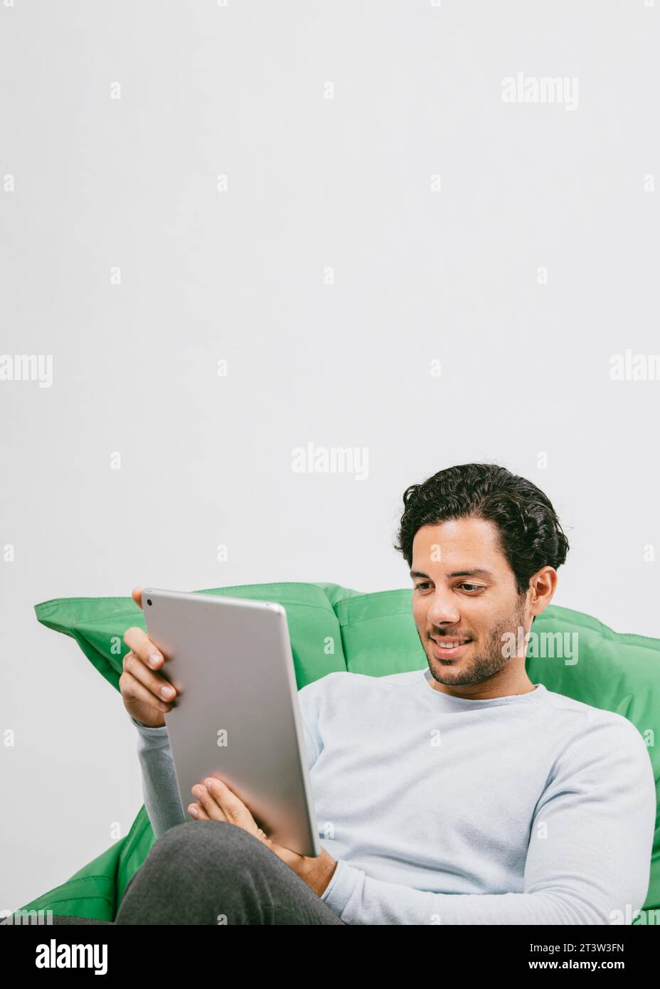 Smiley man having fun with tablet Stock Photo - Alamy