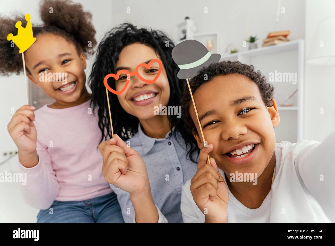 Smiley mother taking selfie with her kids home Stock Photo - Alamy