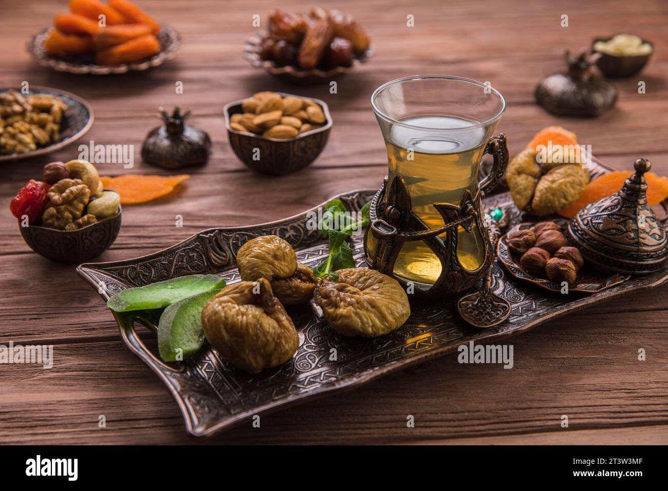 Tea glass with dried figs nuts tray Stock Photo - Alamy