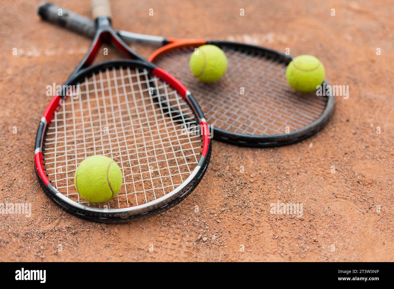 Tennis rackets with balls court Stock Photo - Alamy