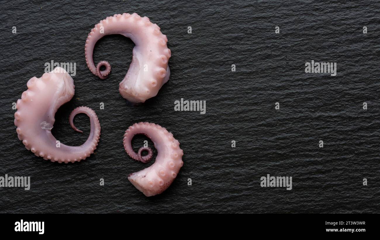 Top view three small pieces octopus Stock Photo - Alamy