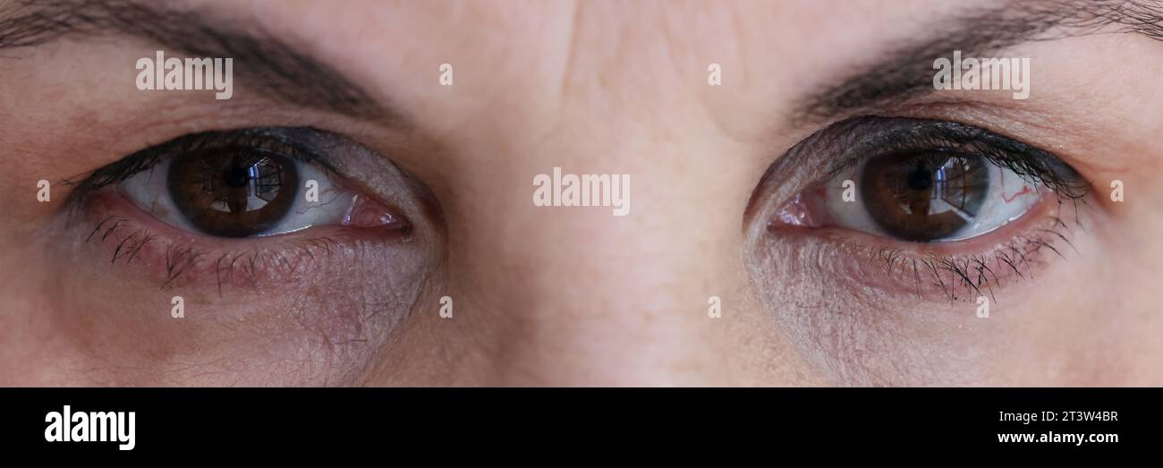 Senior woman face with dark brown eyes and wrinkles Stock Photo - Alamy