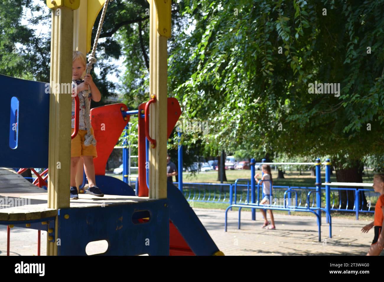 Little children run around and play in the playground. Game center for ...