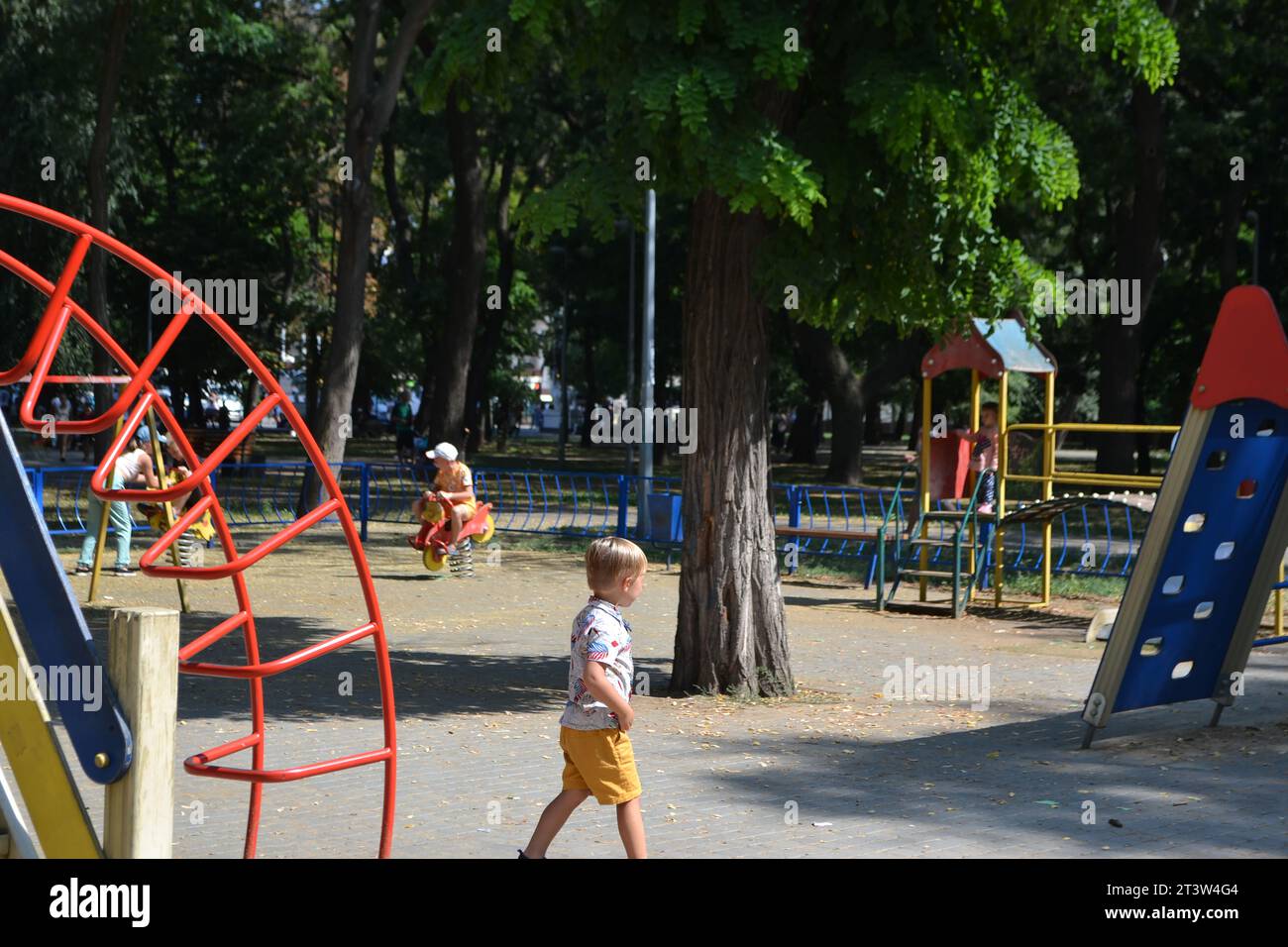 Little children run around and play in the playground. Game center for ...