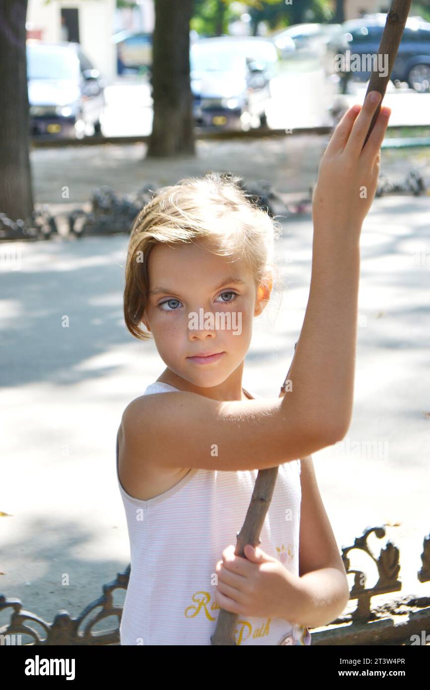 Cute kid girl 10 year old posing on nature background. Looking at ...