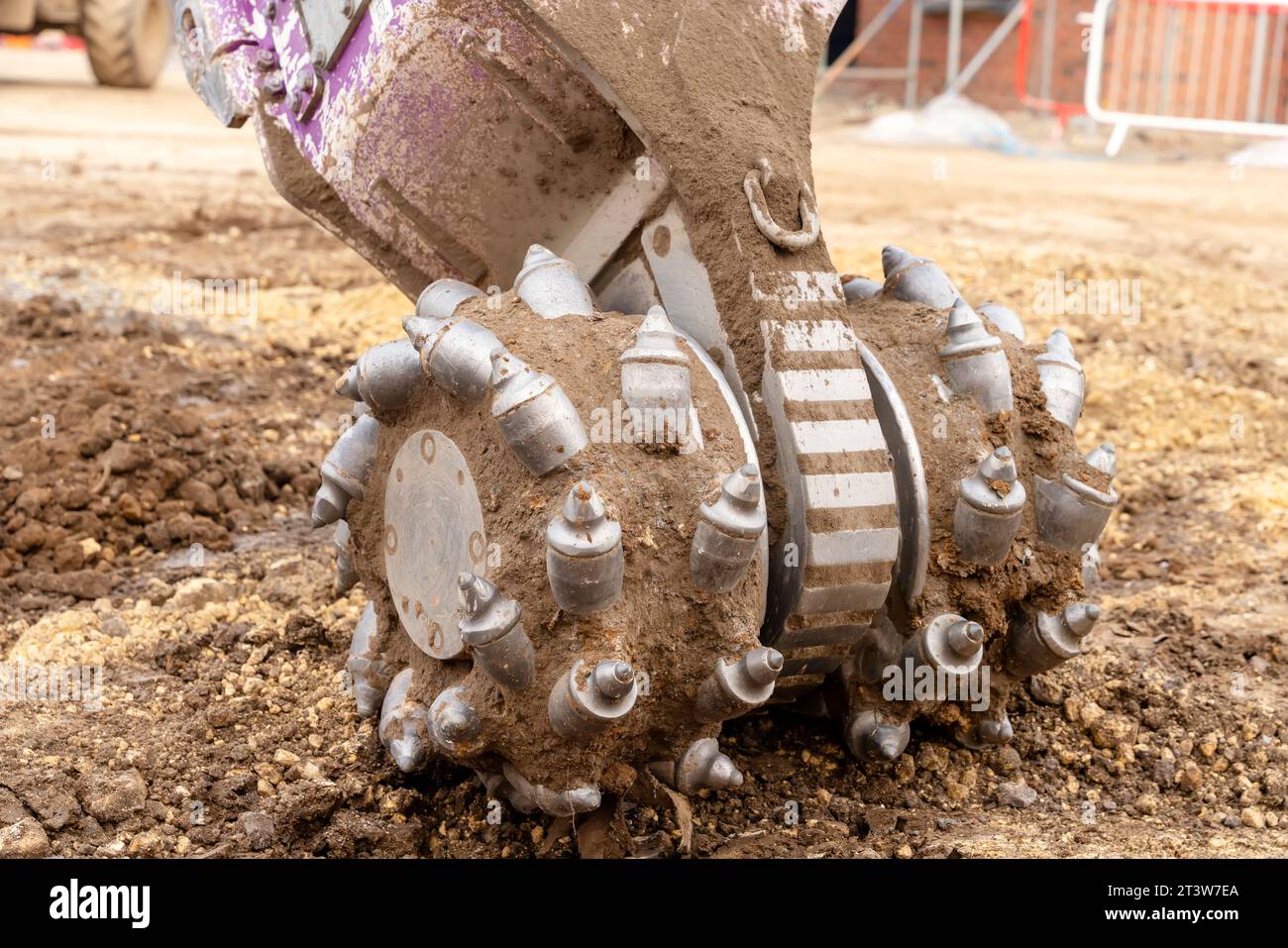 Rotating milling drum close-up. A digger with a hydraulic rockwheel ...
