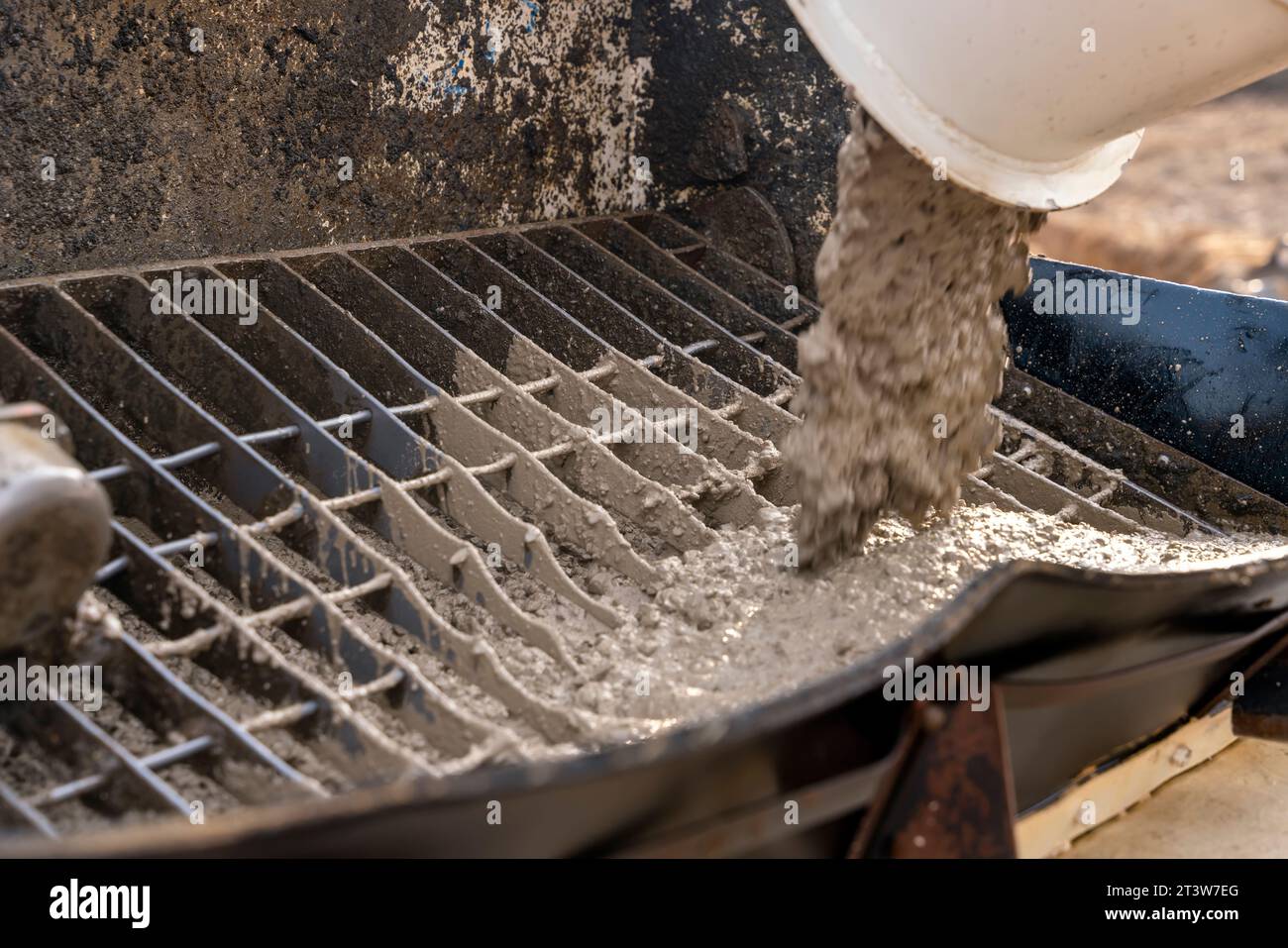 Concrete mixer truck delivered wet concrete and offloading it into ...