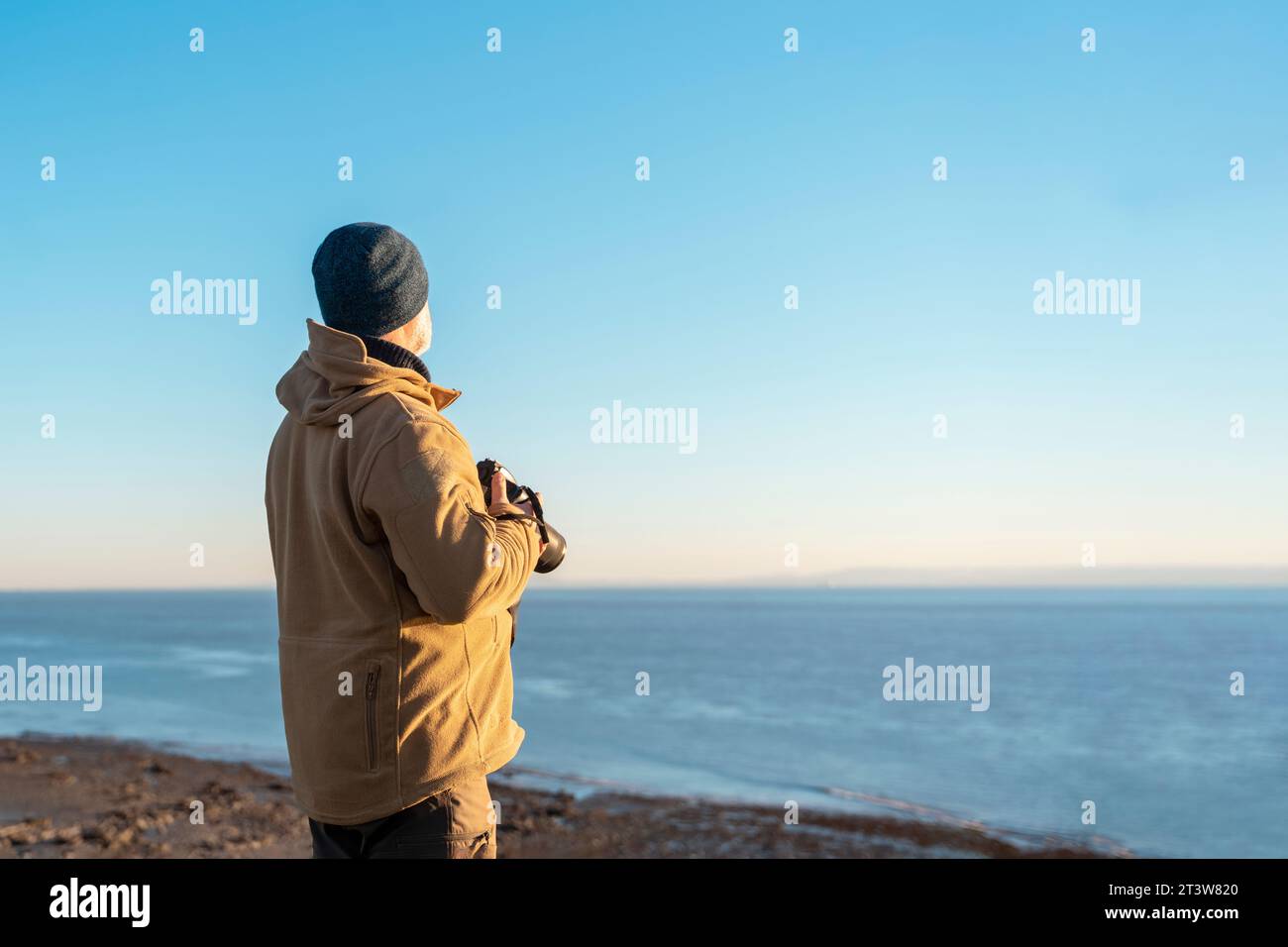 Bearded Man reaching the destination at sunset on a cool day and taking ...